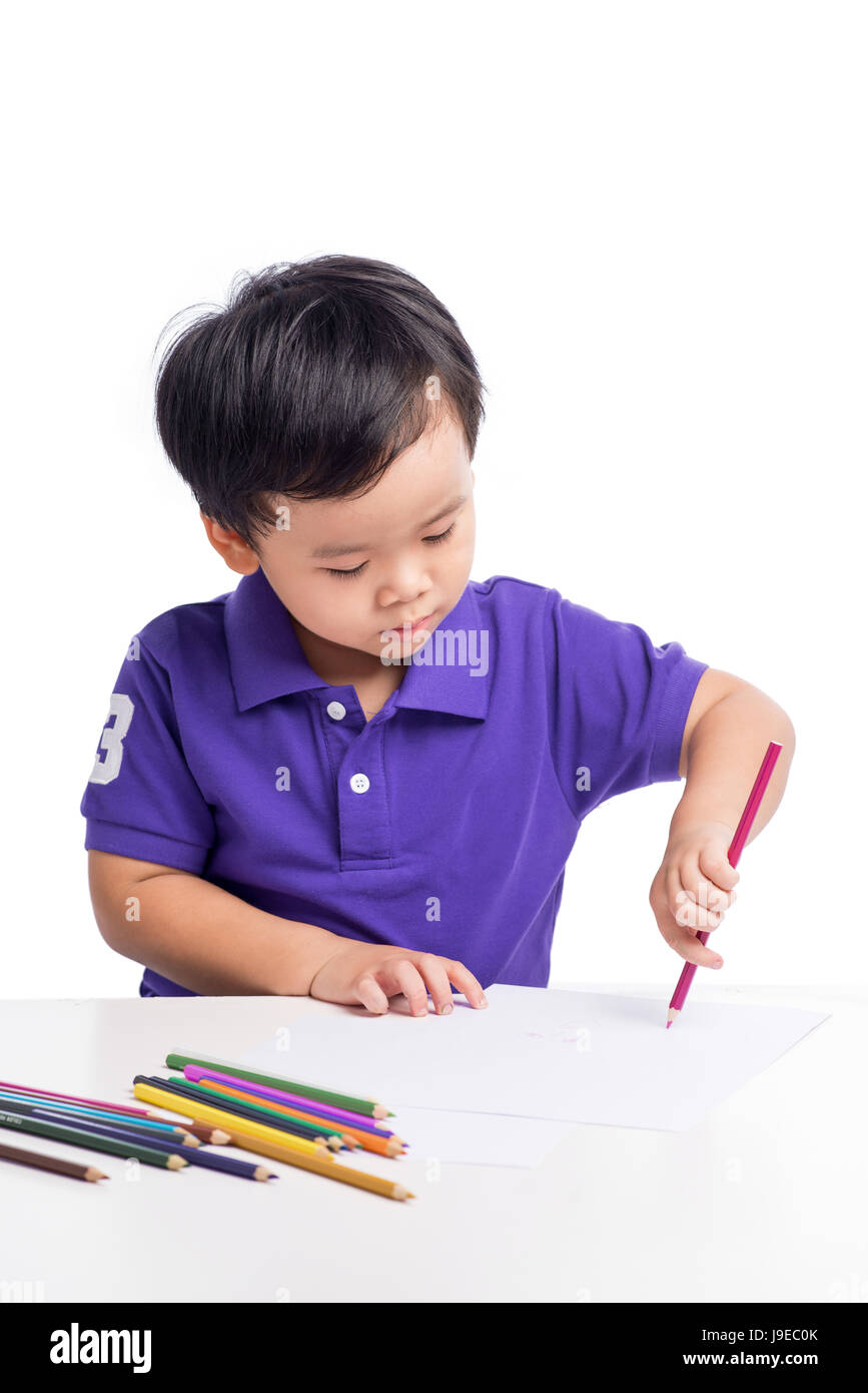 Portrait of cheerful boy drawing with colorful pencils Stock Photo - Alamy
