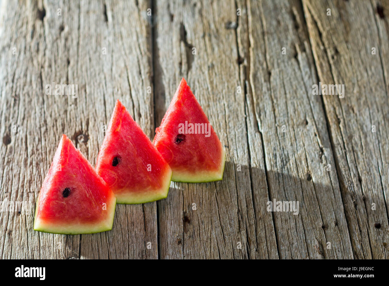 Three small watermelons for eating are placed on a wooden floor Stock ...