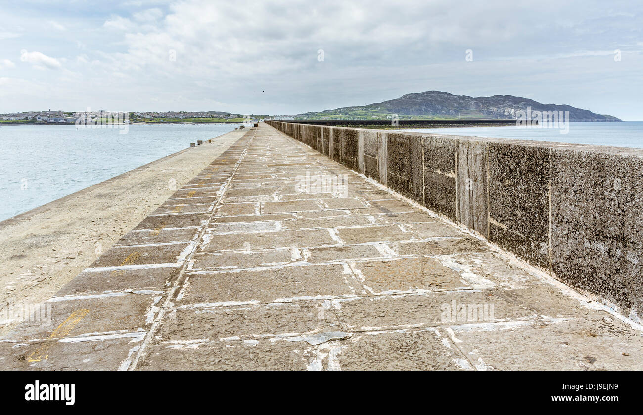 Perspective view along the breakwater at Holyhead on Anglesey Stock ...