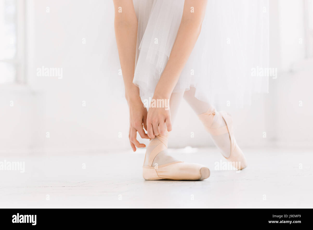 Young ballerina dancing, closeup on legs and shoes, standing in pointe ...