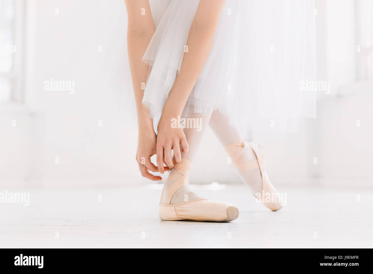 Young ballerina dancing, closeup on legs and shoes, standing in pointe ...