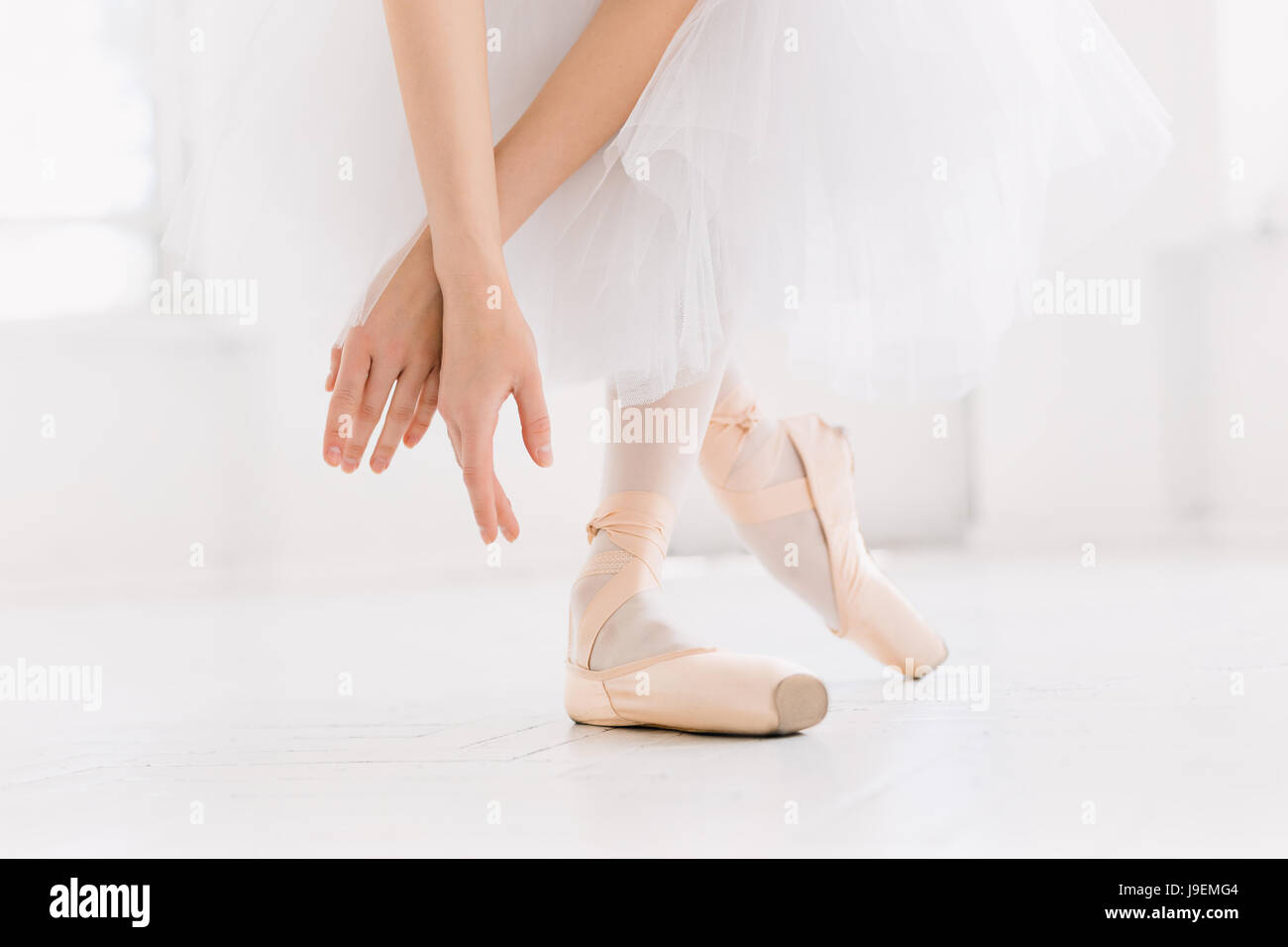 Young ballerina dancing, closeup on legs and shoes, standing in pointe ...