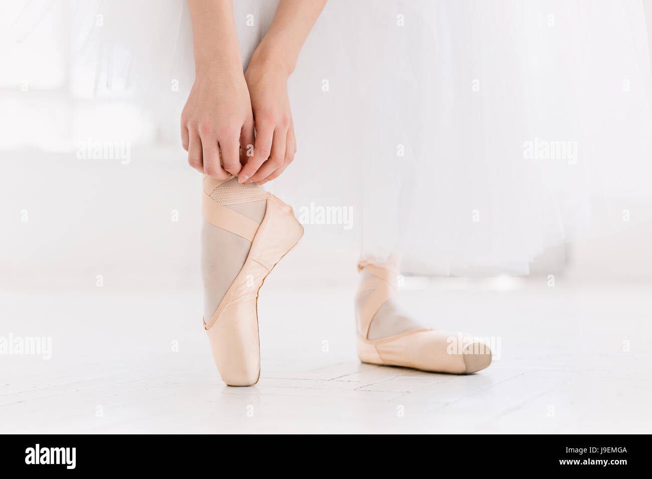 Young ballerina dancing, closeup on legs and shoes, standing in pointe ...