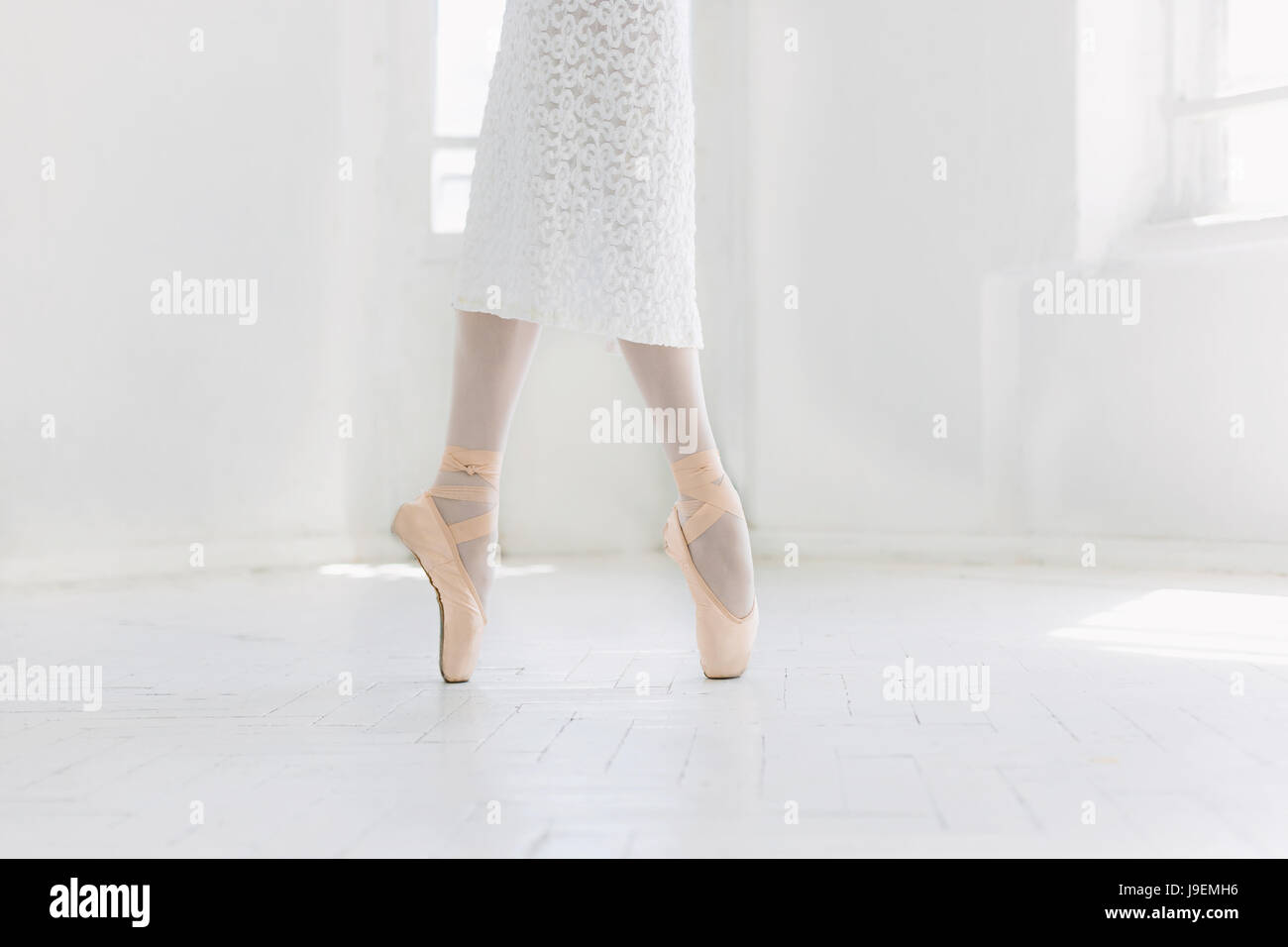 Young ballerina dancing, closeup on legs and shoes, standing in pointe ...