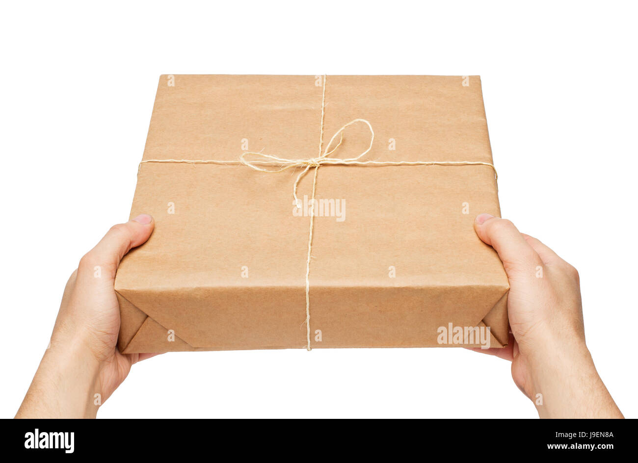 Man's hands gives parcel wrapped in brown paper and tied with rough ...