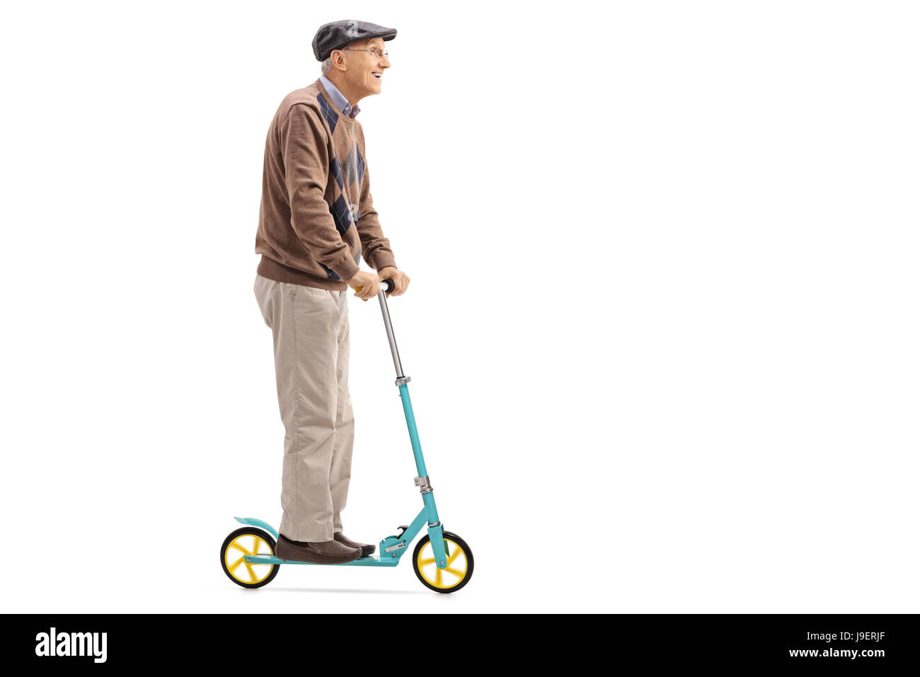Full length profile shot of a senior riding a scooter isolated on white ...