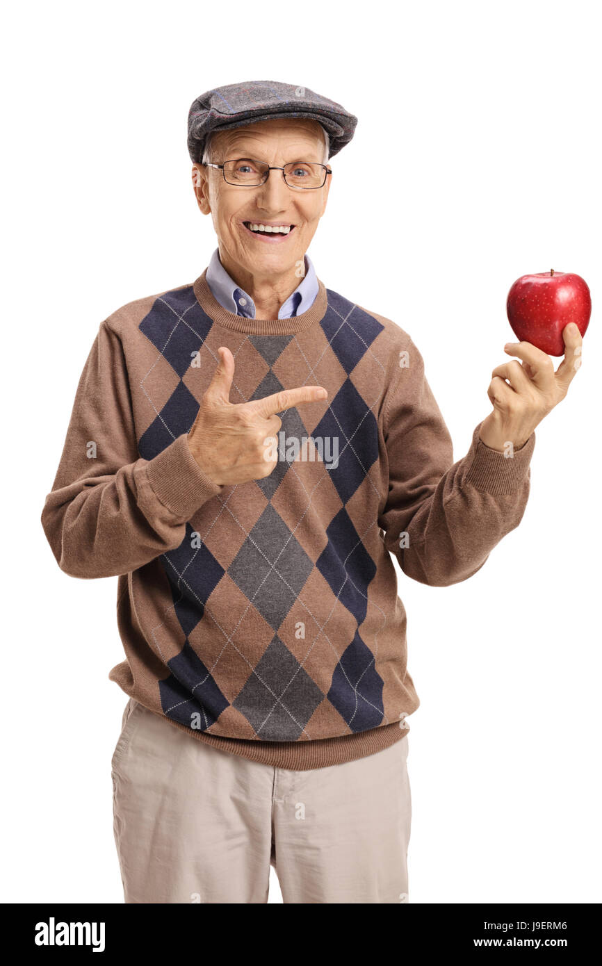 Senior holding an apple and pointing isolated on white background Stock ...