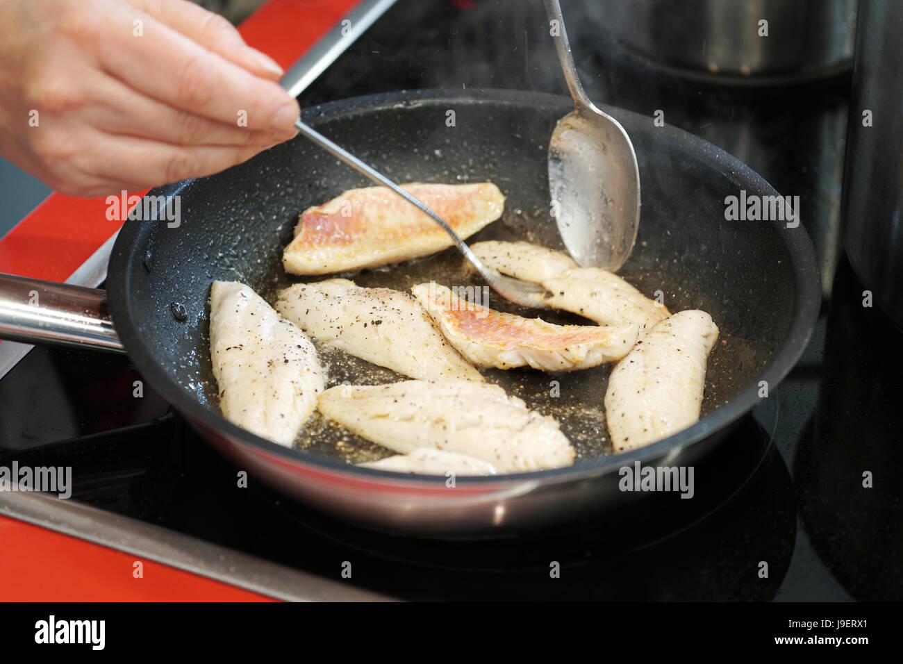 frying red mullet fish fillets Stock Photo - Alamy