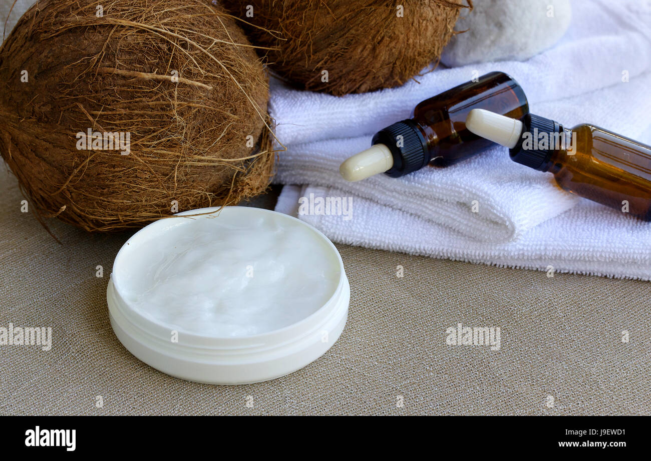 Coconut butter cream. Coconuts,dropper bottles with coconut oil,white ...