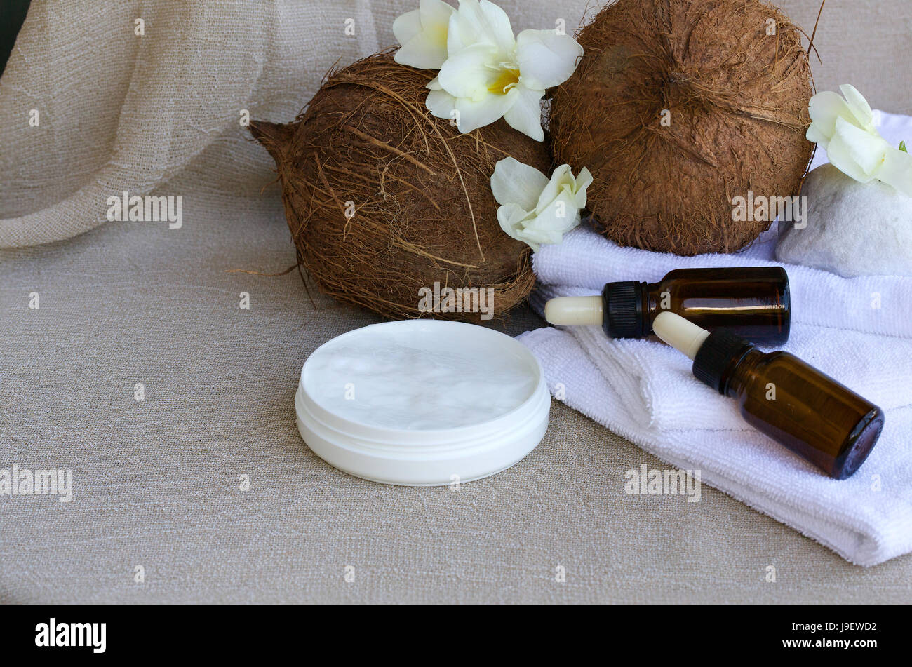 Coconut butter cream. Coconuts,dropper bottles with coconut oil,white ...