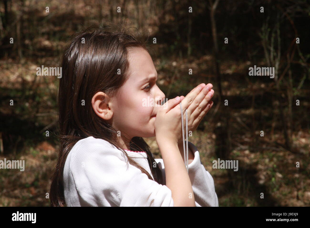 Young girl in the woods hand whistling Stock Photo - Alamy