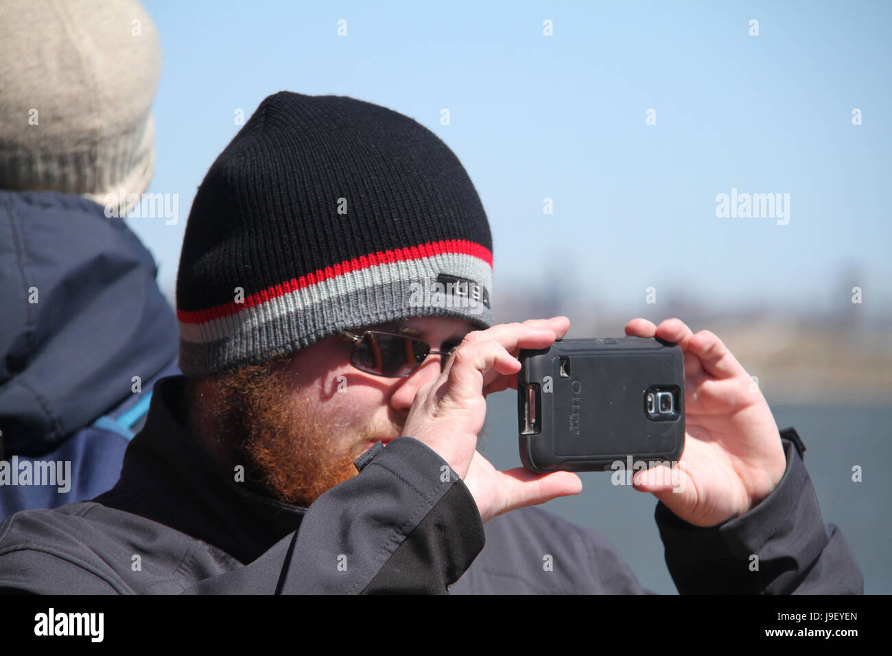 Young man taking travel pictures using cell phone Stock Photo - Alamy
