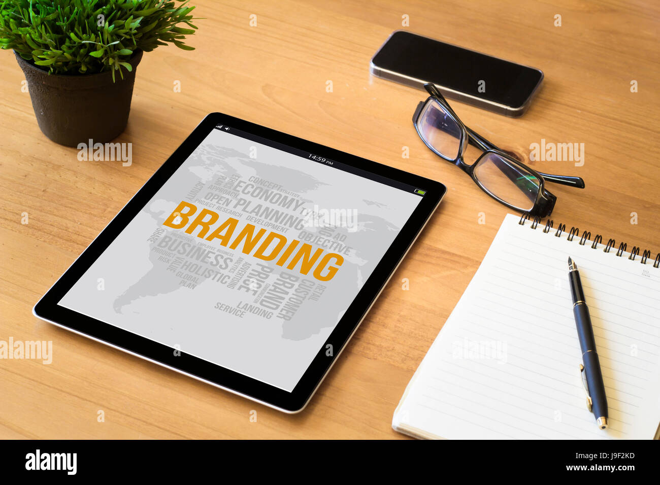 branding screen tablet on desktop Stock Photo - Alamy