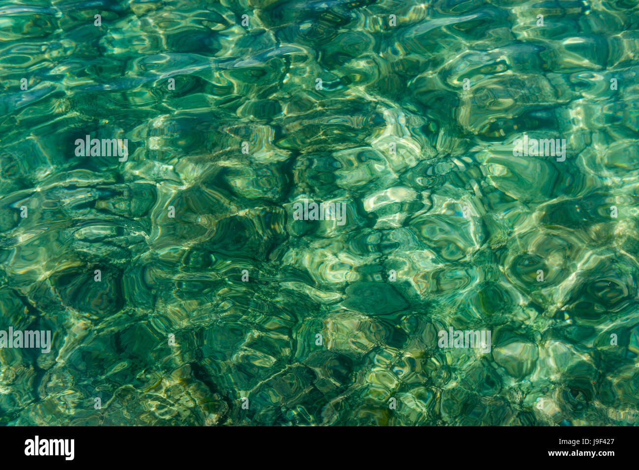Reflections and patterns of water ripples at sea Stock Photo - Alamy