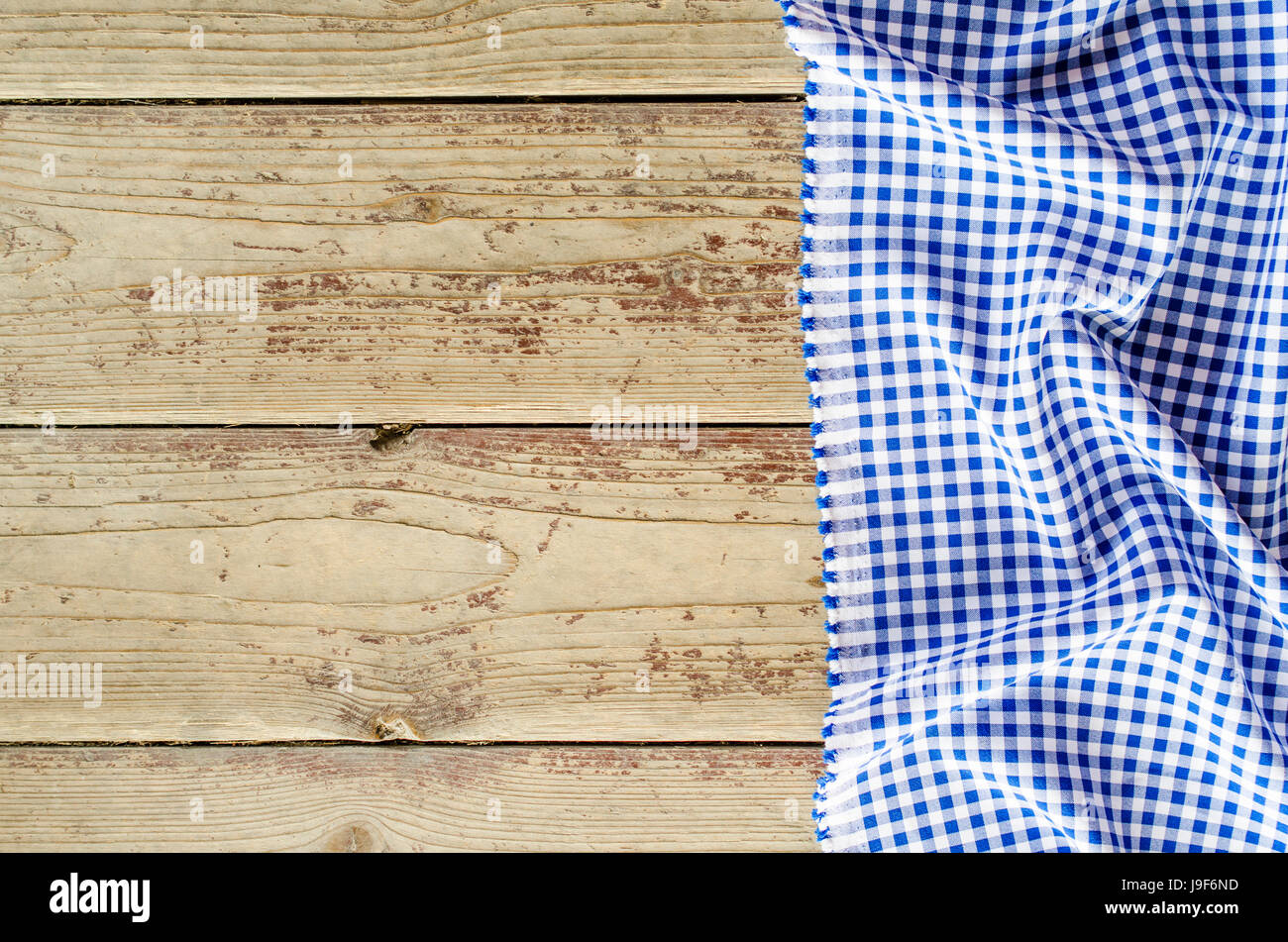 Blue folded tablecloth over wooden table Stock Photo - Alamy