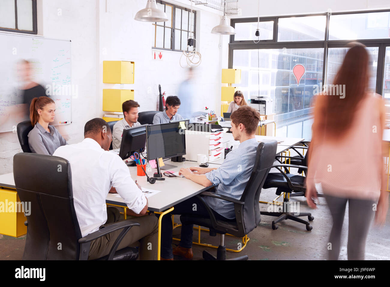 Staff walking through a busy open plan office Stock Photo - Alamy