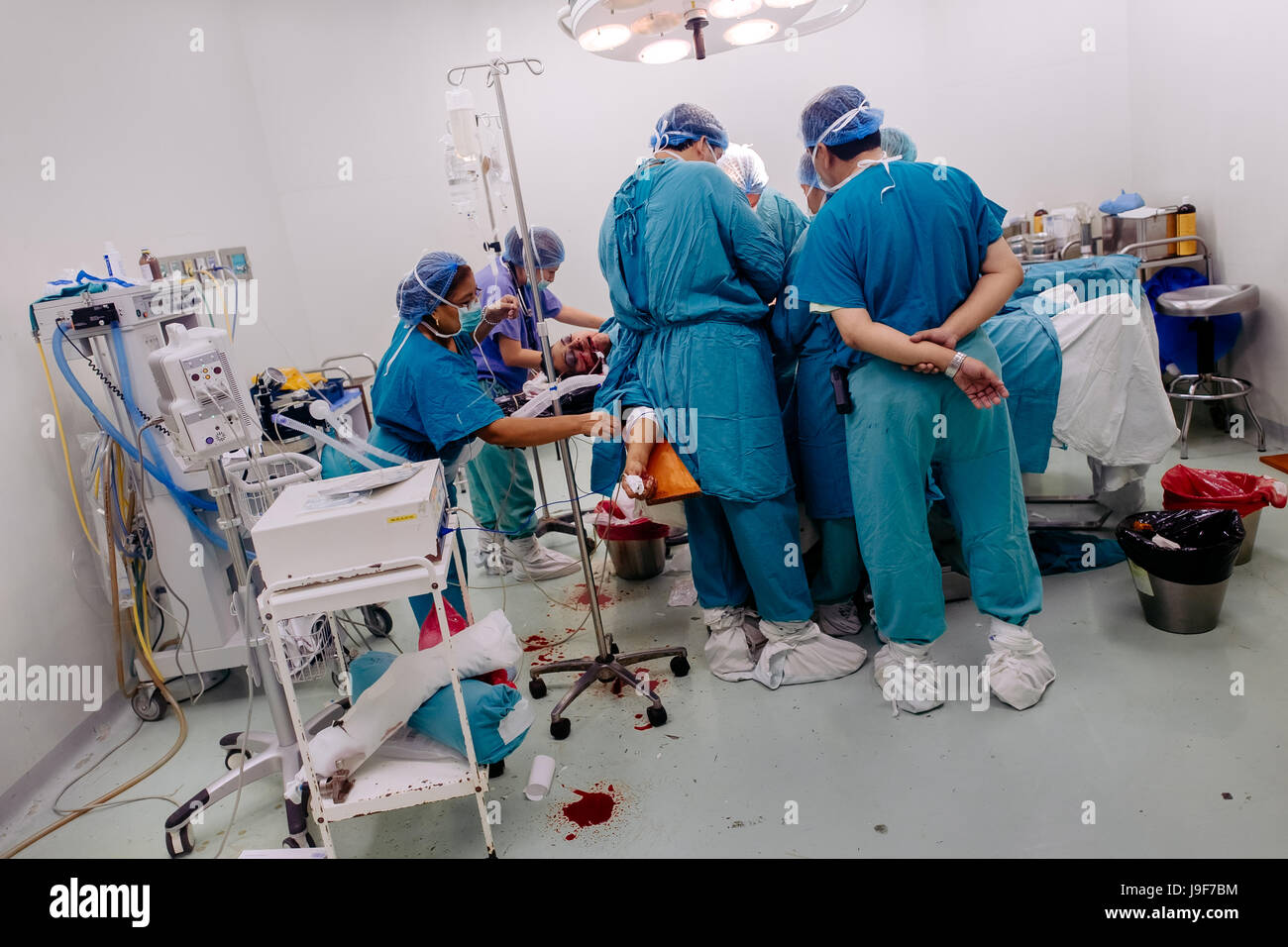 A team of emergency physicians perform a life-saving surgery on a young ...