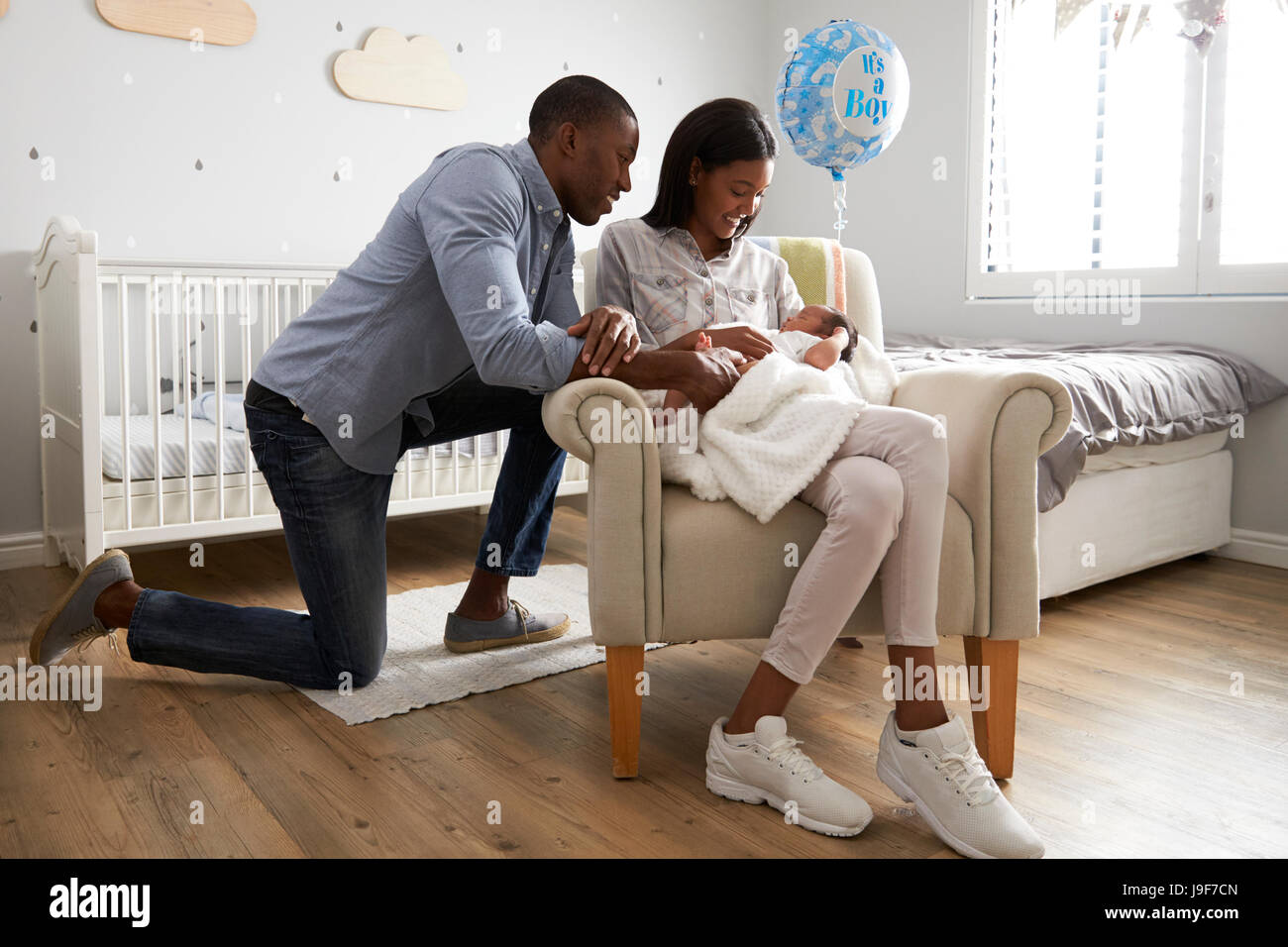 Parents Home from Hospital With Newborn Baby In Nursery Stock Photo - Alamy