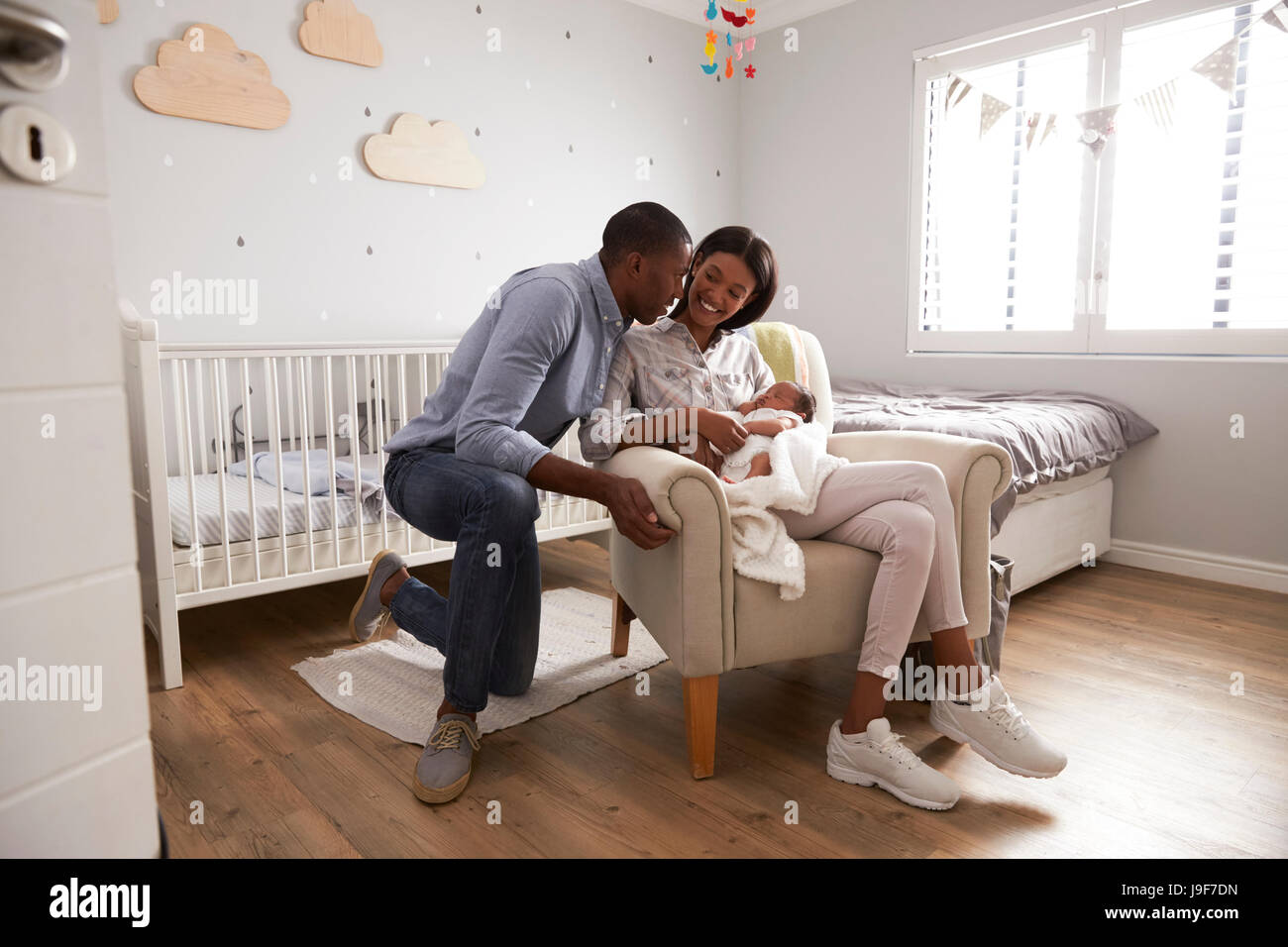 Parents Home from Hospital With Newborn Baby In Nursery Stock Photo - Alamy