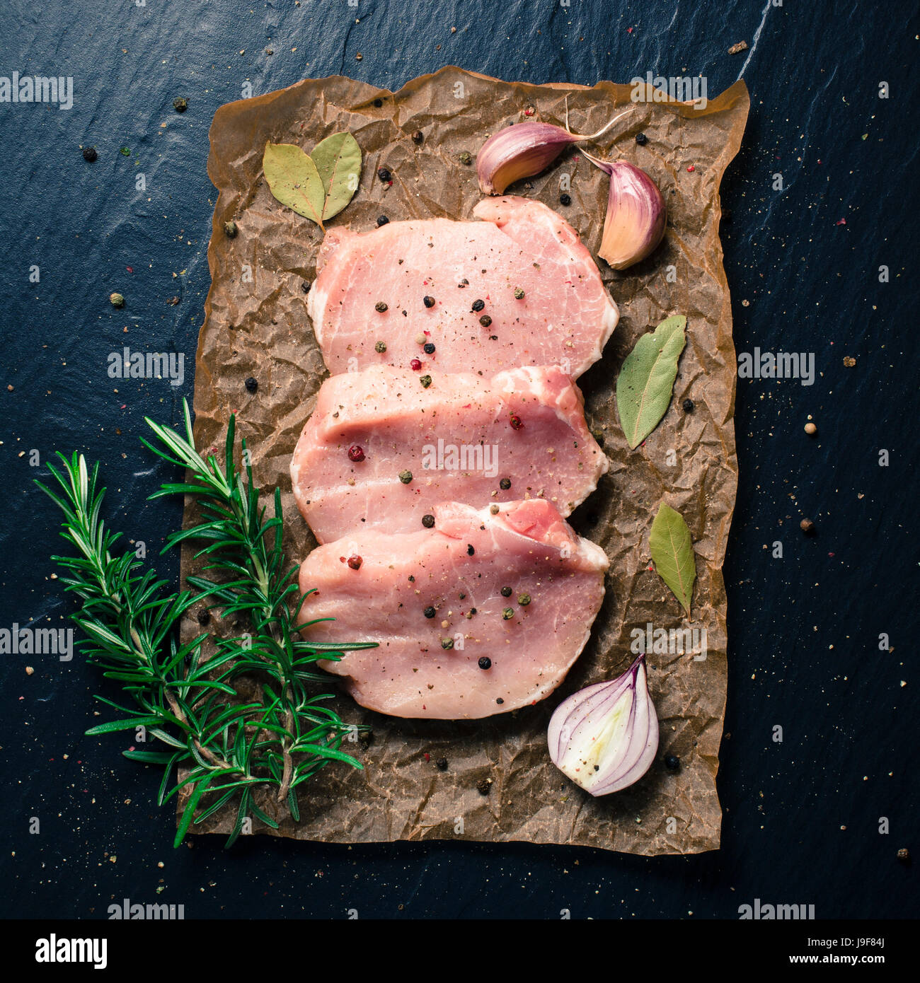 Raw pork meat on dark background Stock Photo - Alamy