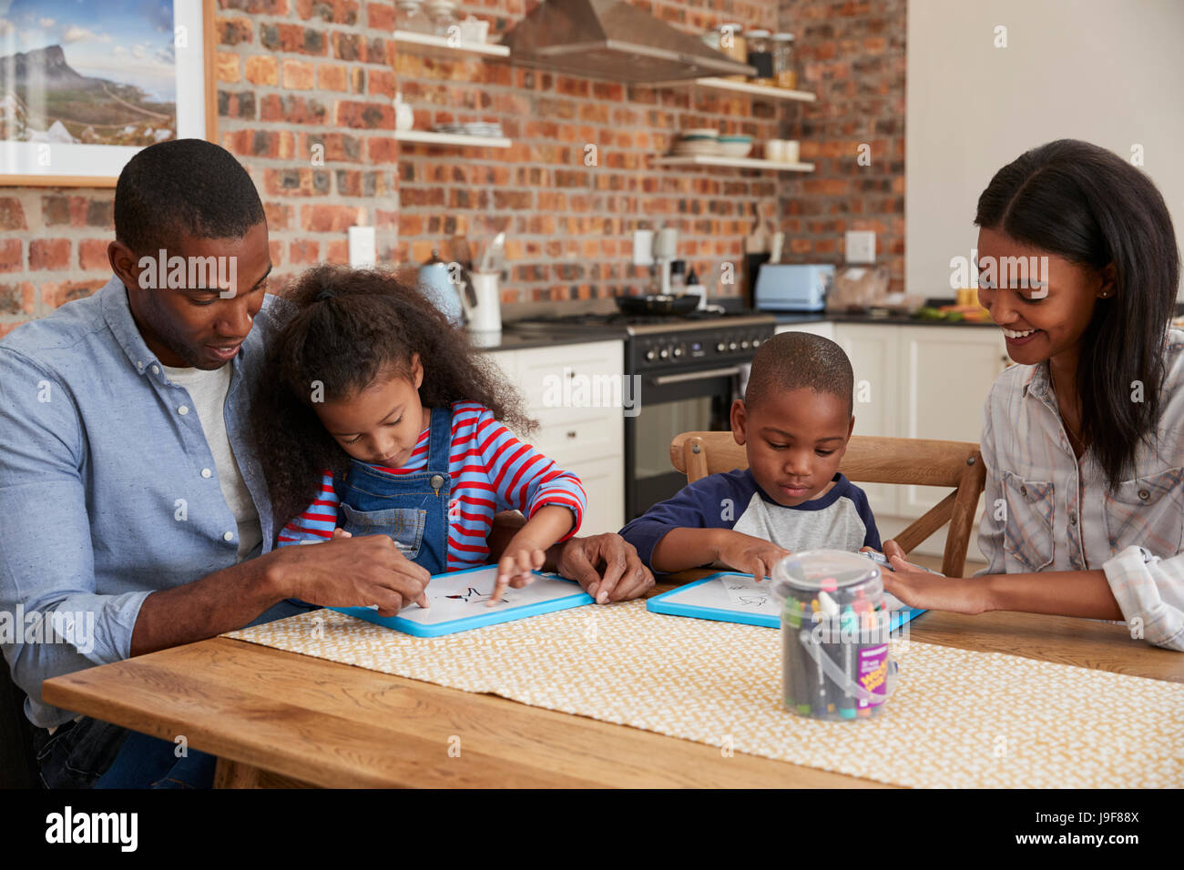 Parents And Children Drawing On Whiteboards At Table Stock Photo - Alamy