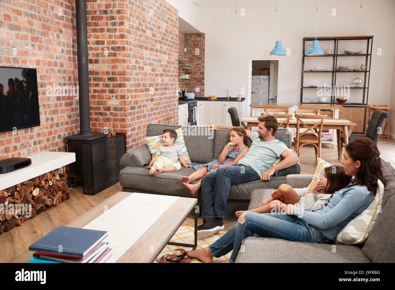 Family of five sitting on sofa at home hi-res stock photography and ...