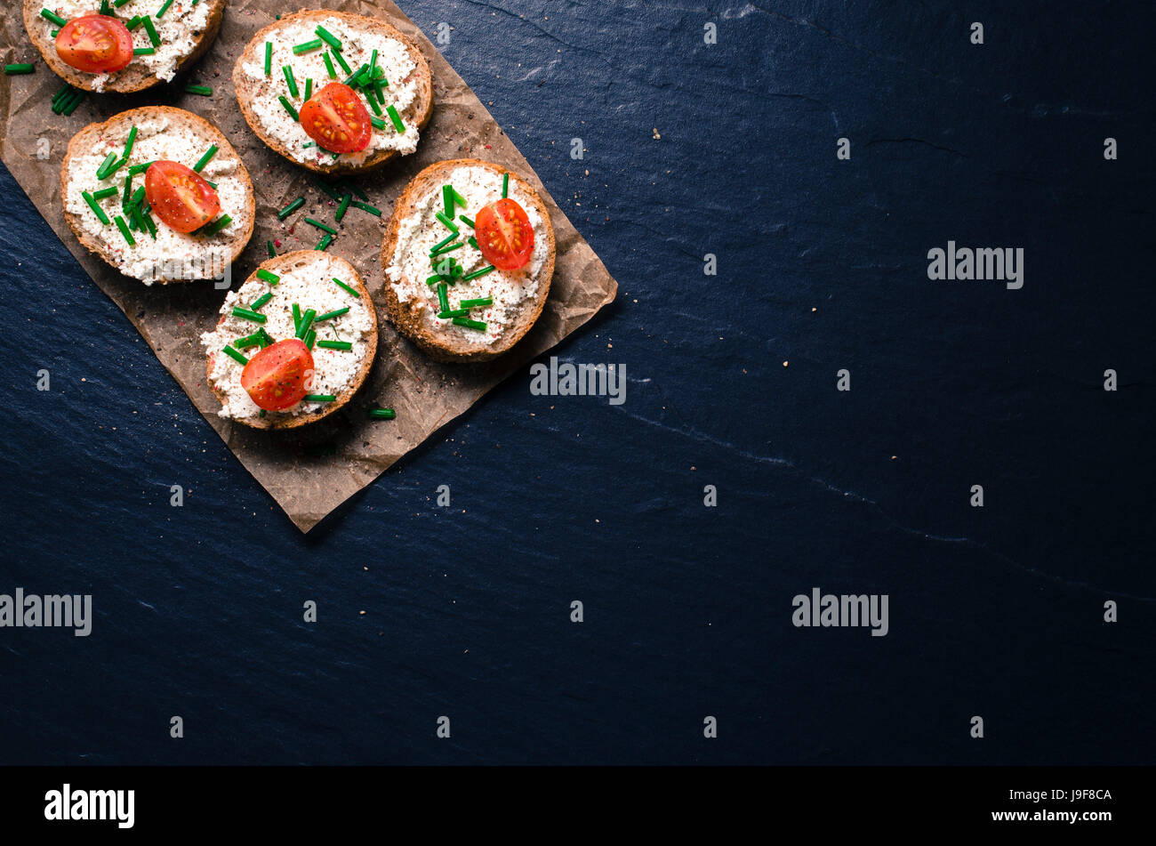 Mini sandwiches on dark background. Top view Stock Photo - Alamy