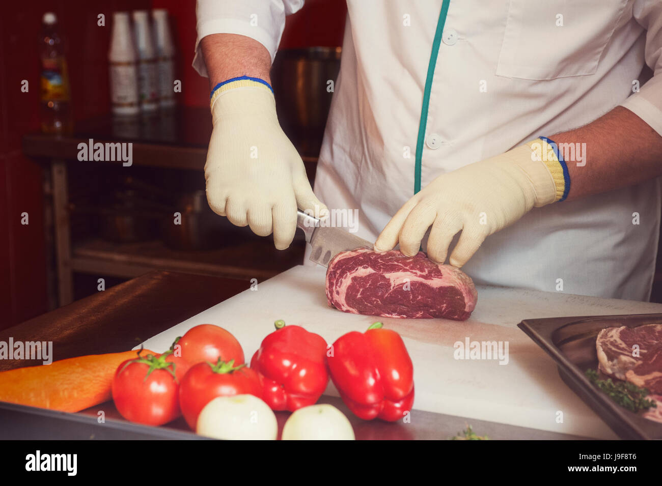 Chef cutting meat Stock Photo - Alamy