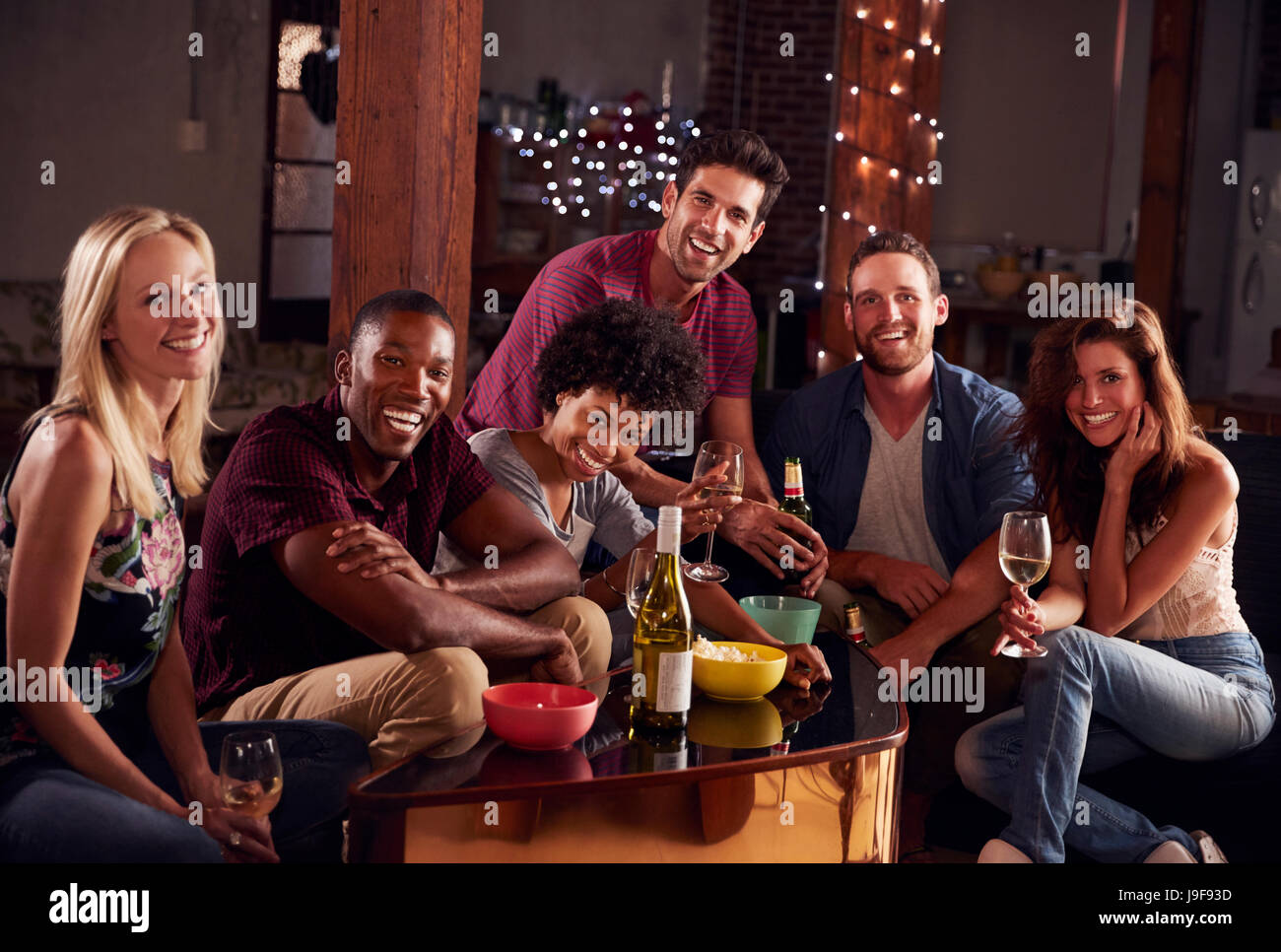 Young adult friends having a party at home look to camera Stock Photo ...