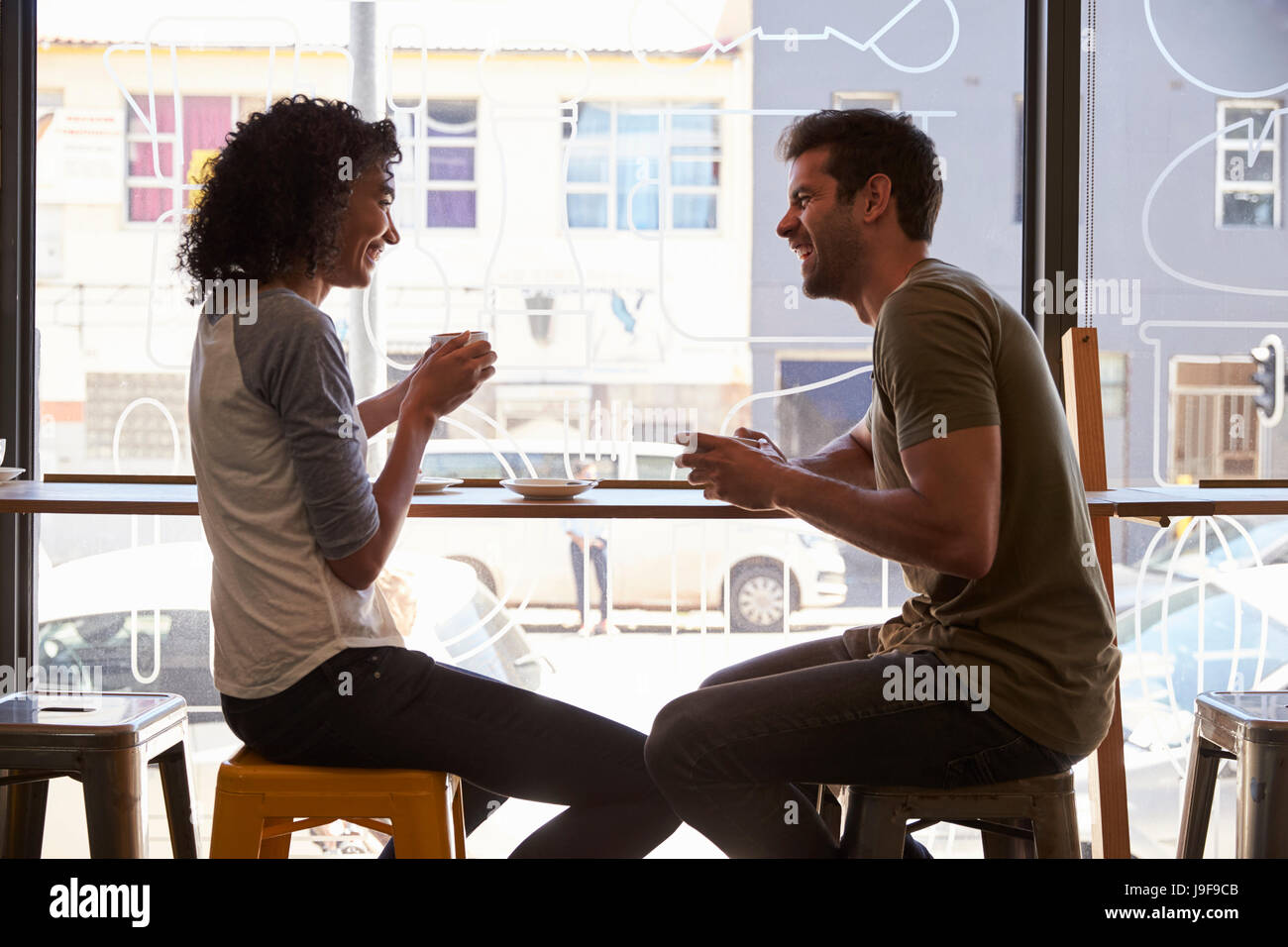 Couple Meeting For Date In Coffee Shop Stock Photo - Alamy