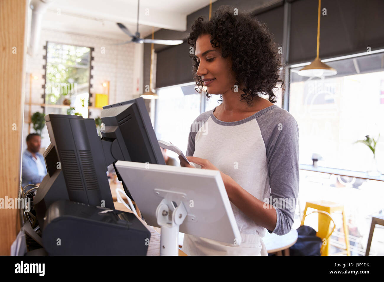 Waitress At Cash Register In Coffee Shop Stock Photo - Alamy