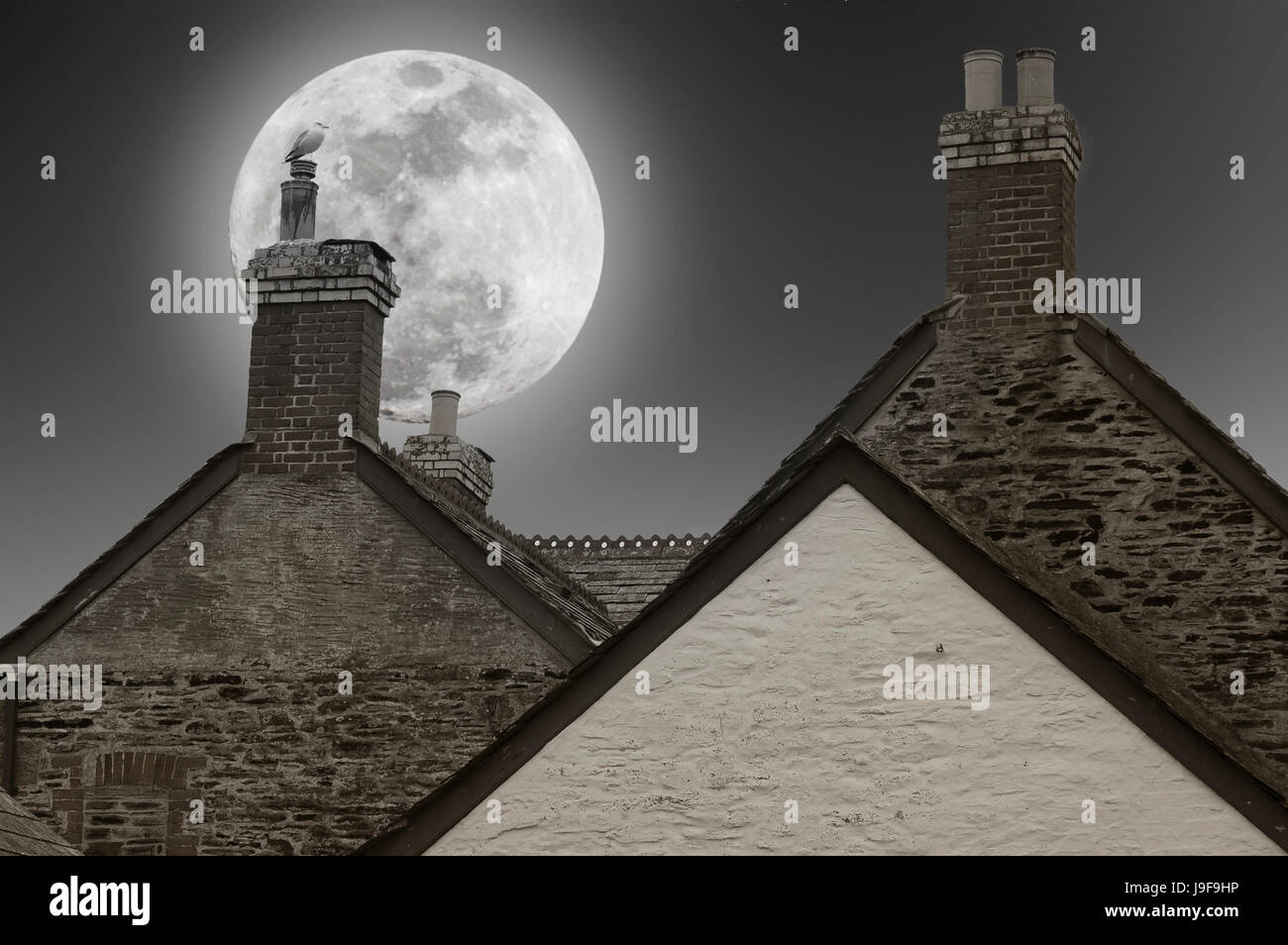 A night of full moon over the chimneys of the houses Stock Photo - Alamy