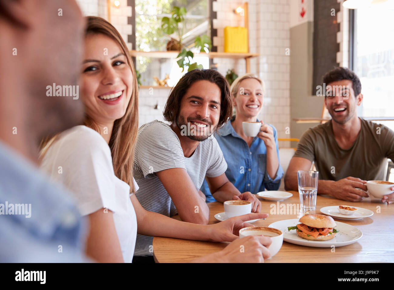 Group Of Friends Meeting For Lunch In Coffee Shop Stock Photo - Alamy