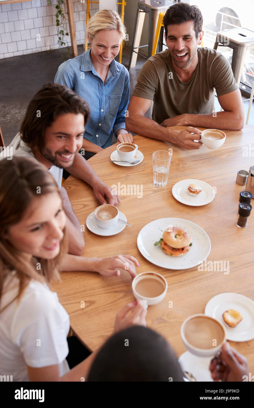 Overhead Shot Of Friends Meeting For Lunch In Coffee Shop Stock Photo ...