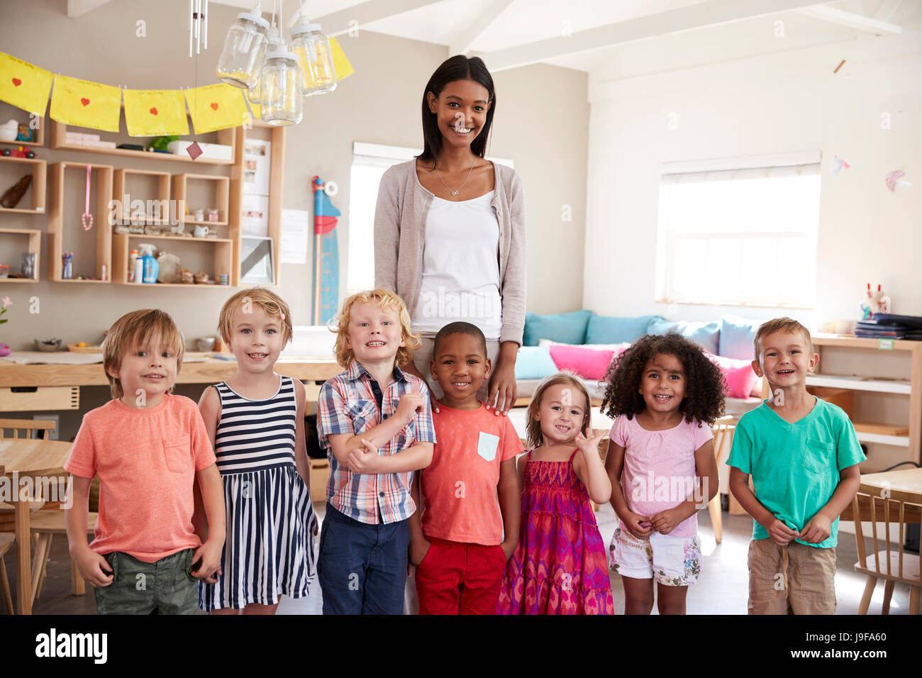 Portrait Of Teacher With Pupils In Montessori School Classroom Stock ...