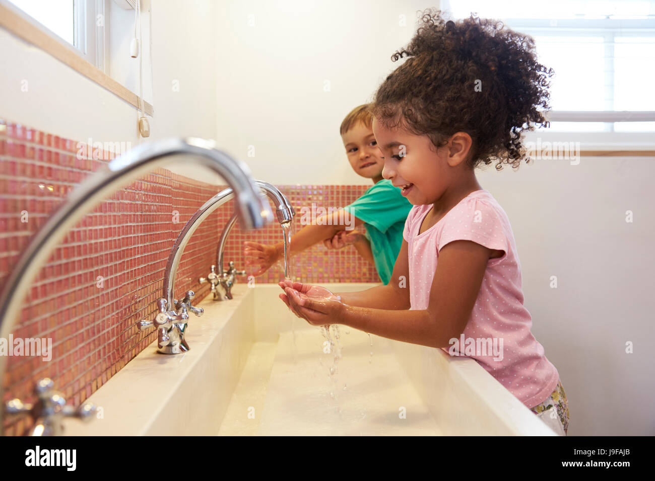 Children hands washing standing hi-res stock photography and images - Alamy