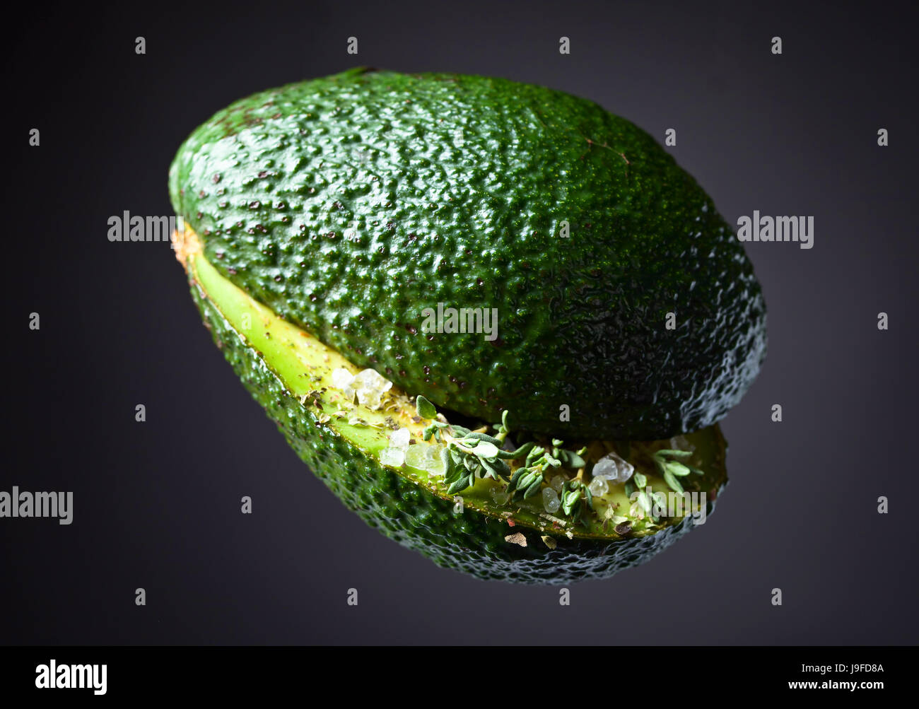 Avocado with spices , thyme and sea salt .Healthy vegetarian food Stock ...