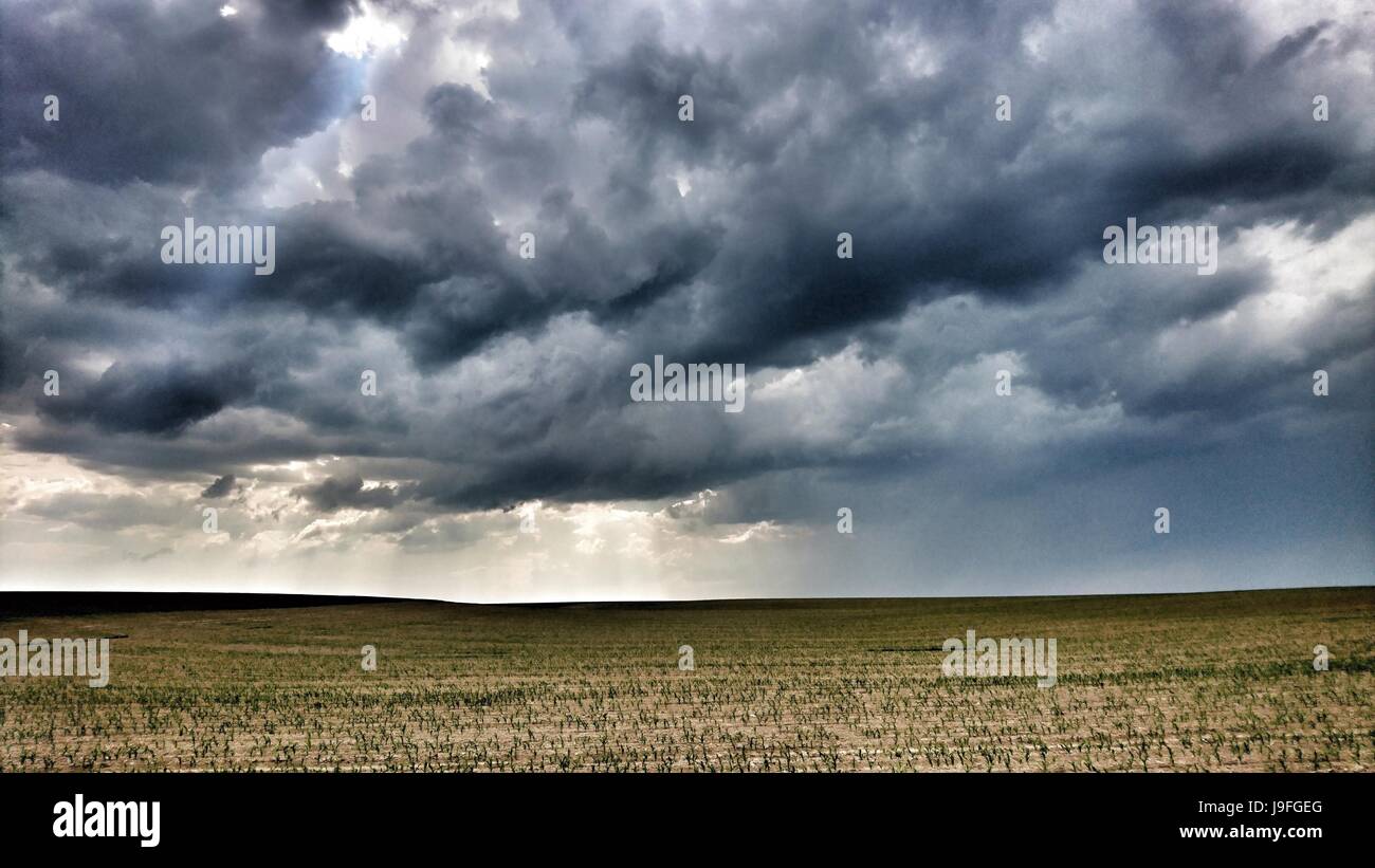Cloudy dramatic dark sky with clouds over a field Stock Photo - Alamy