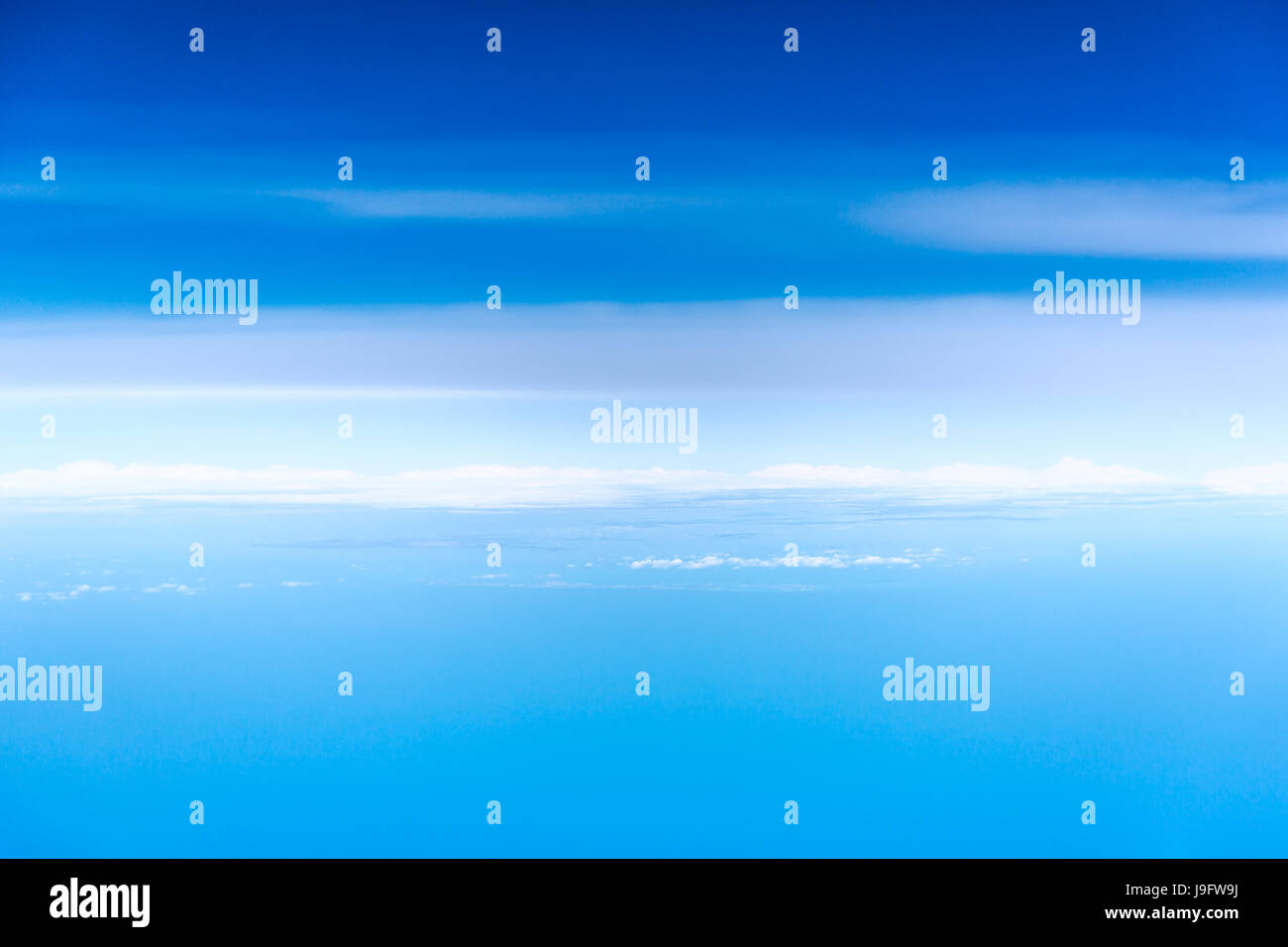 Flight over the Atlantic Ocean. View from airplane window to the clouds ...