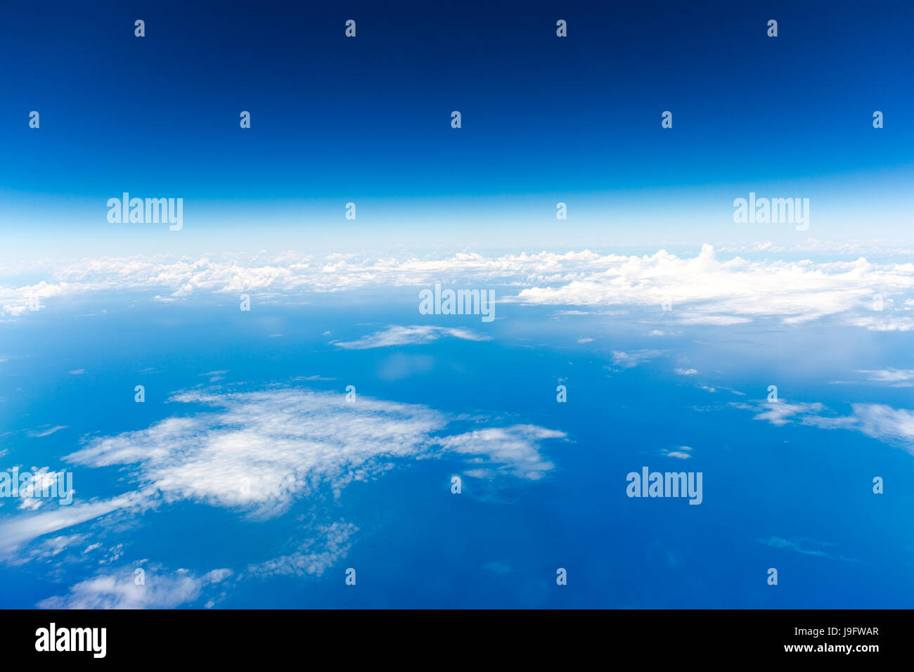 Flight over the Atlantic Ocean. View from airplane window to the clouds ...