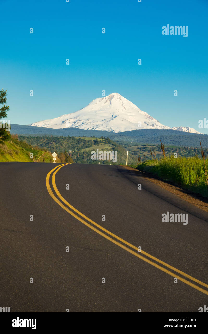 Eastern side of Mount Hood rising above a highway in Oregon Stock Photo ...