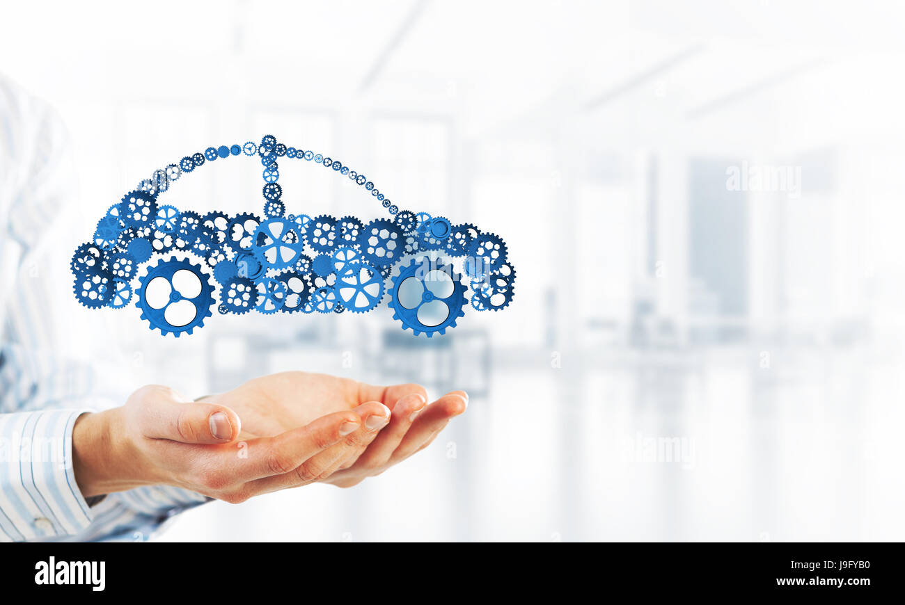 Close up of male hand showing car symbol made with gears and cogwheels ...