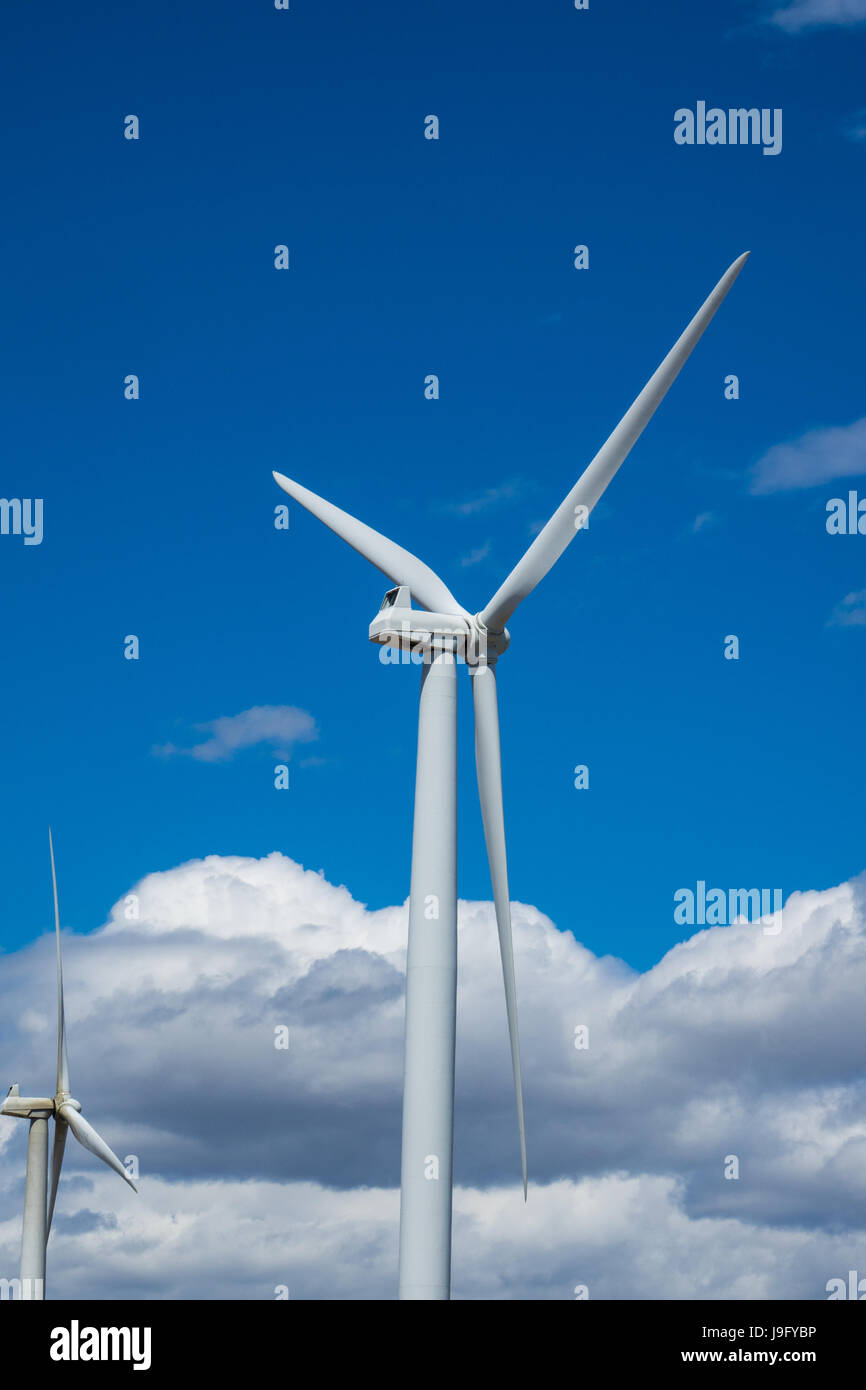 Single white wind turbine rising in a blue sky Stock Photo - Alamy