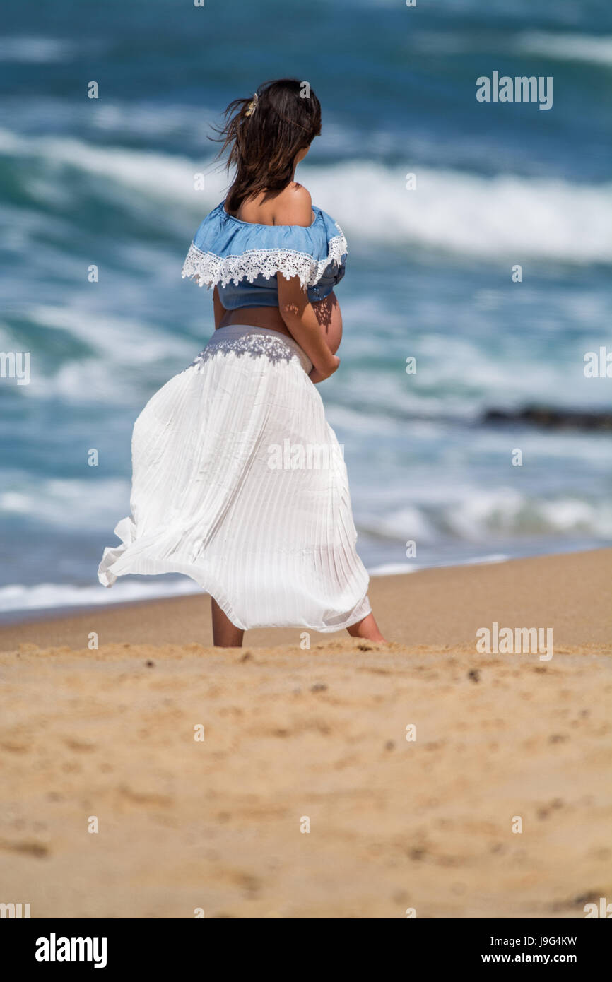 Ericeira Portugal. 20 May 2017.Pregnant woman walking on a beach in ...