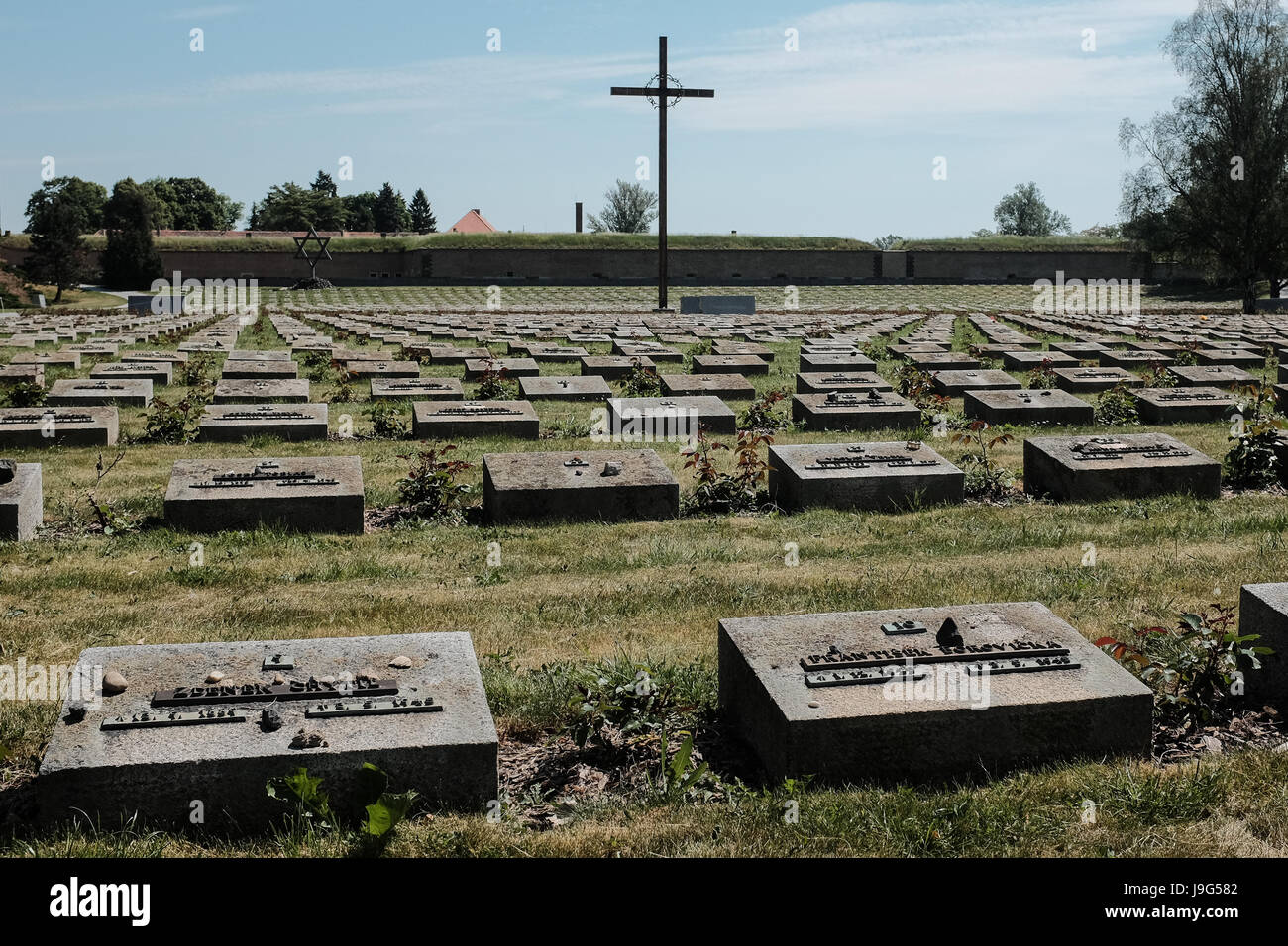 A cross and a Star of David dominate the Terezin Memorial Cemetery ...