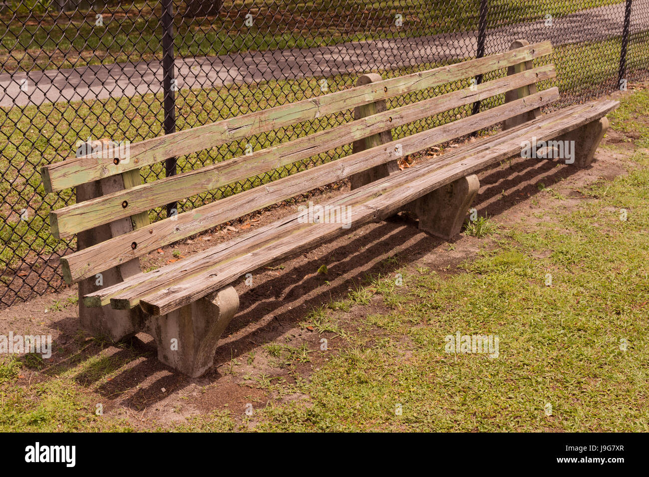 Outdoor Park Bench Near A Fence Stock Photo - Alamy