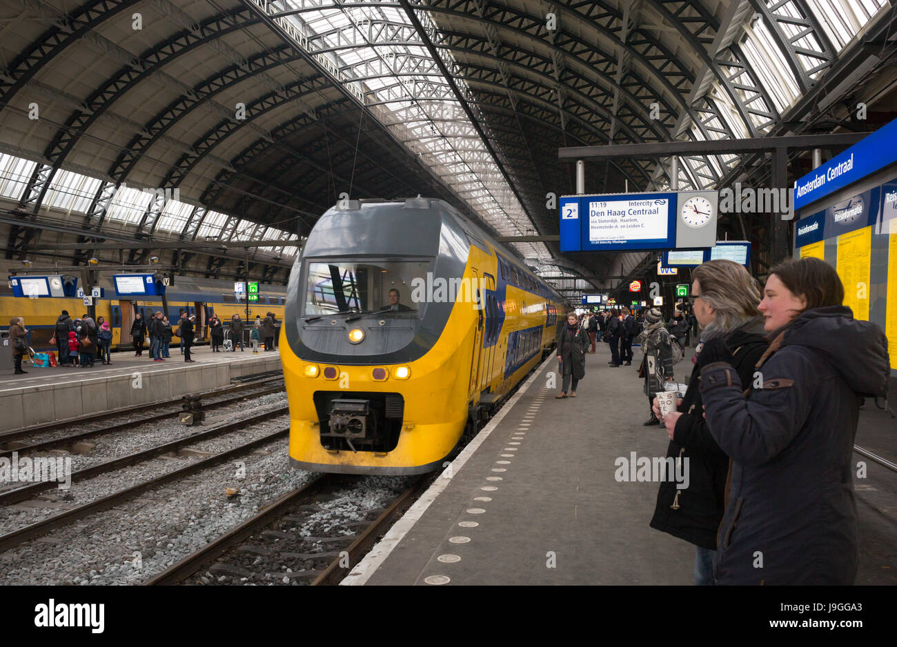Electric multiple unit train alongside platform in Amsterdam Centraal ...