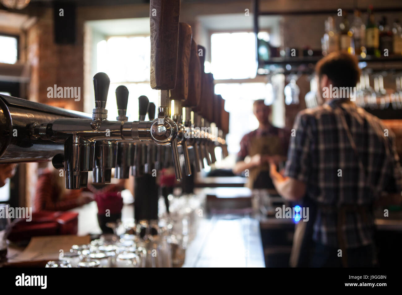 A lot of Golden beer taps at the bar Stock Photo - Alamy