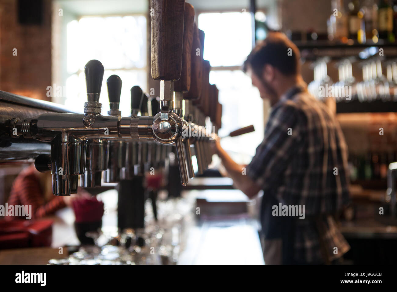 A lot of Golden beer taps at the bar Stock Photo - Alamy