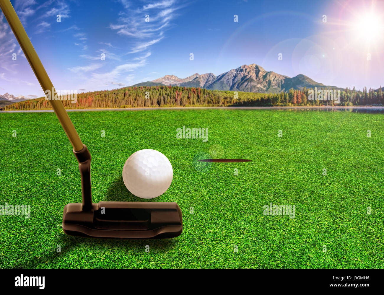 Golfer using a putter club to hit a golf ball on a beautiful golf ...
